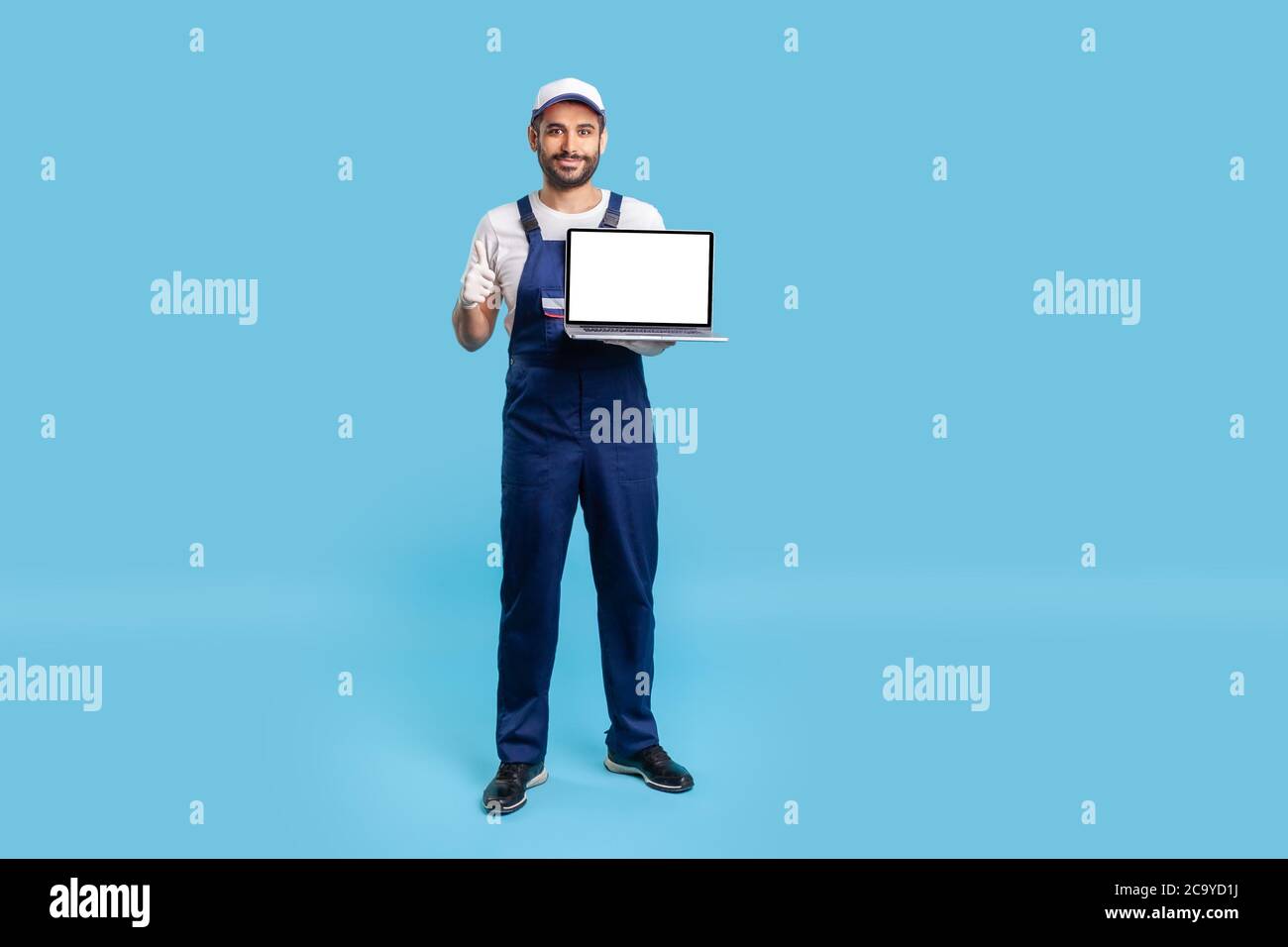 Full length high-qualified worker man in uniform showing thumbs up and ...
