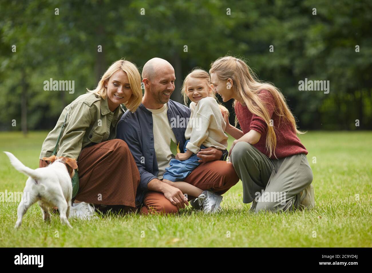 Full length portrait of happy modern happy family with two daughters ...