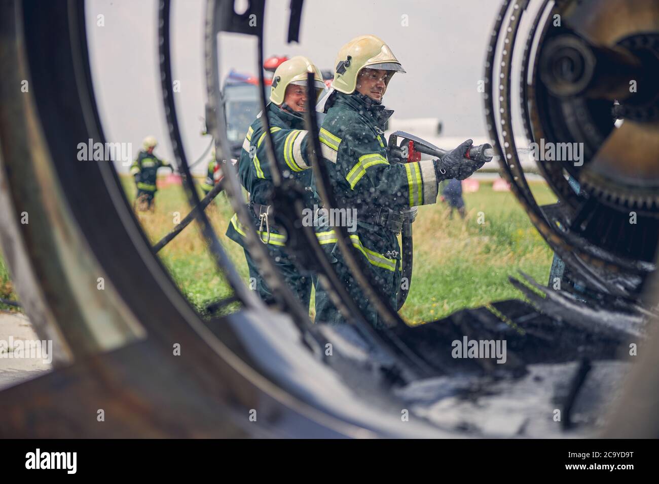 Firefighter in green fireproof uniform at the emergency operation Stock ...