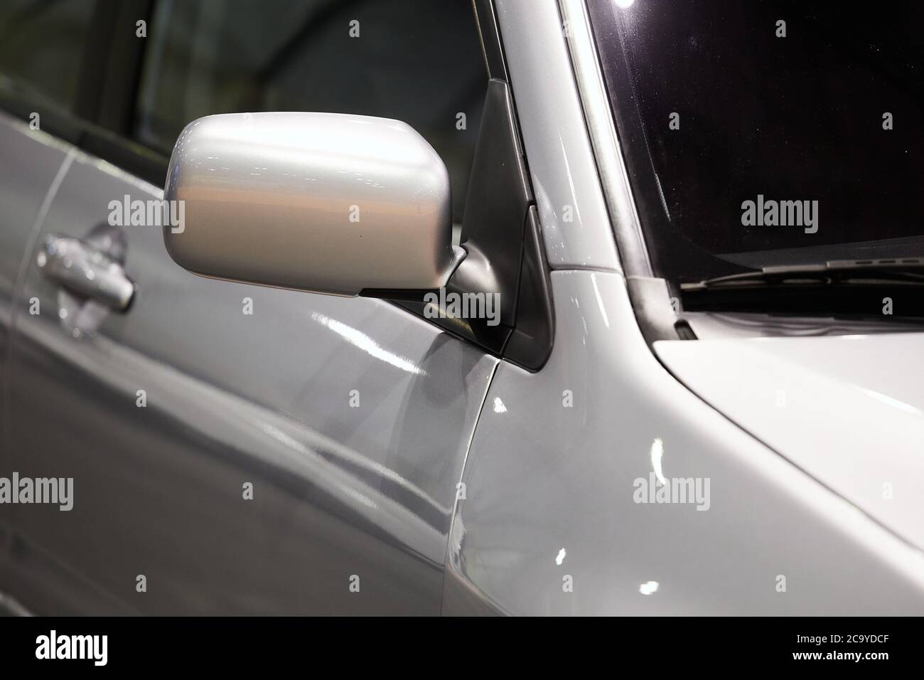 Closeup shot of a brand new silver car's side mirror with its ...