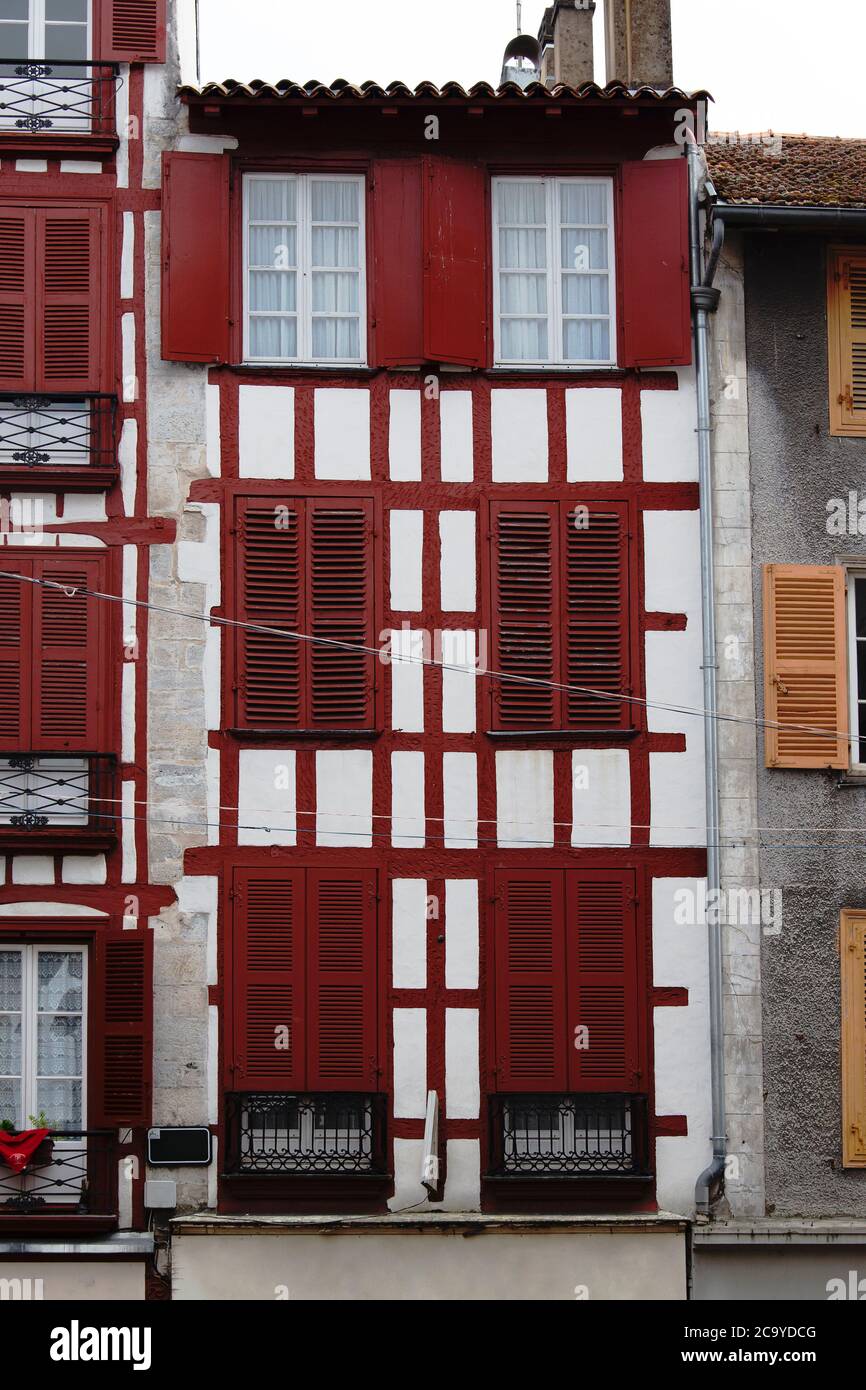 Vertical eye-level shot of the facade of a red and white building with ...