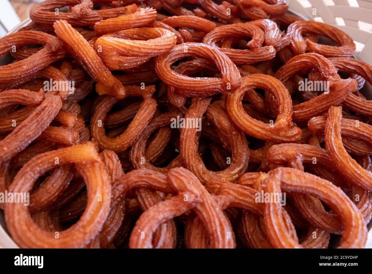 Turkish Dessert Churros Halka Tatli frying in hot oil. Turkish ...