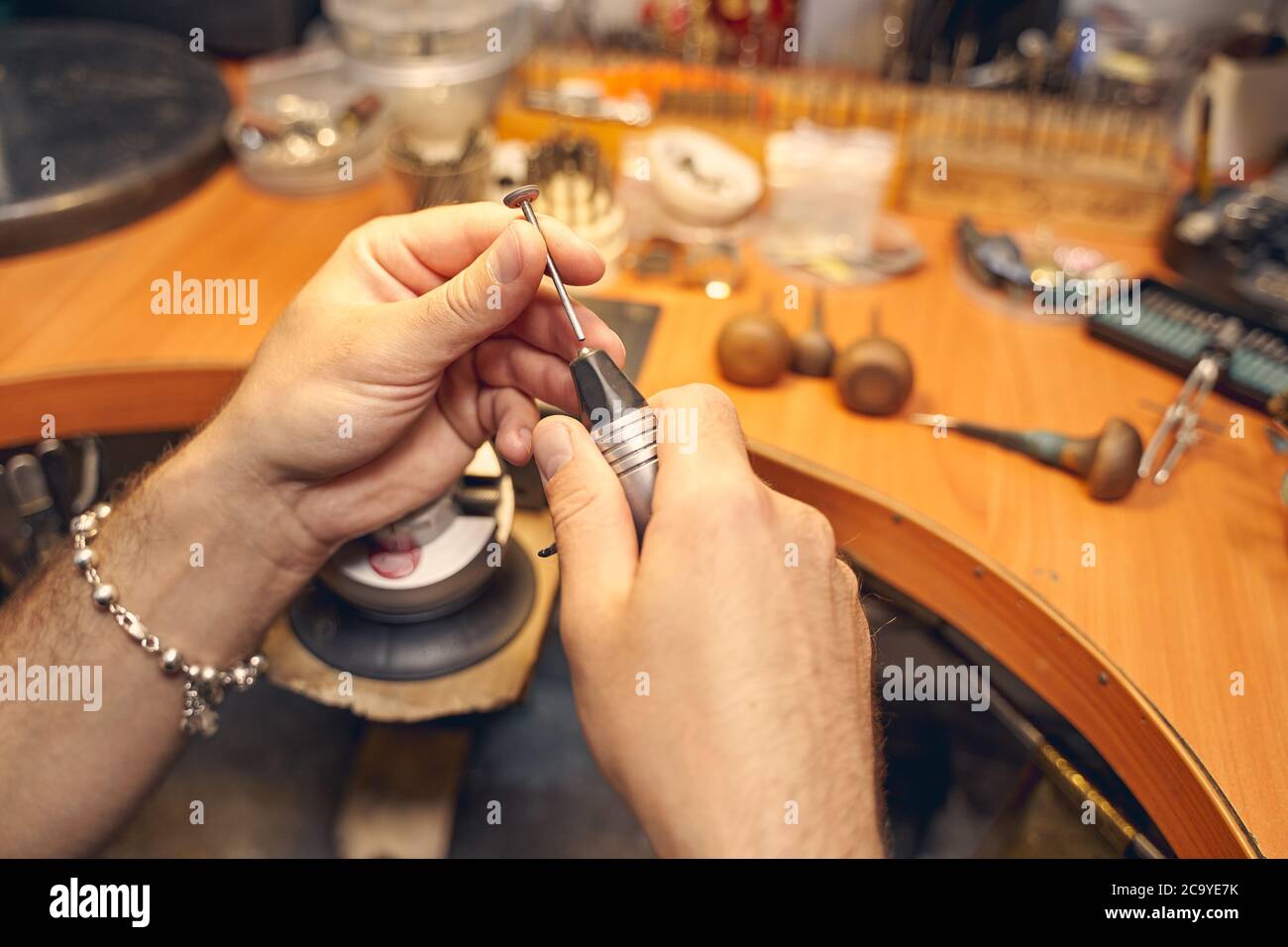 Professional jeweler holding a polishing instrument in his hand Stock ...