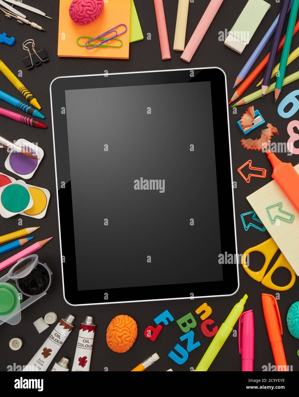Digital tablet and school supplies on blackboard Stock Photo - Alamy
