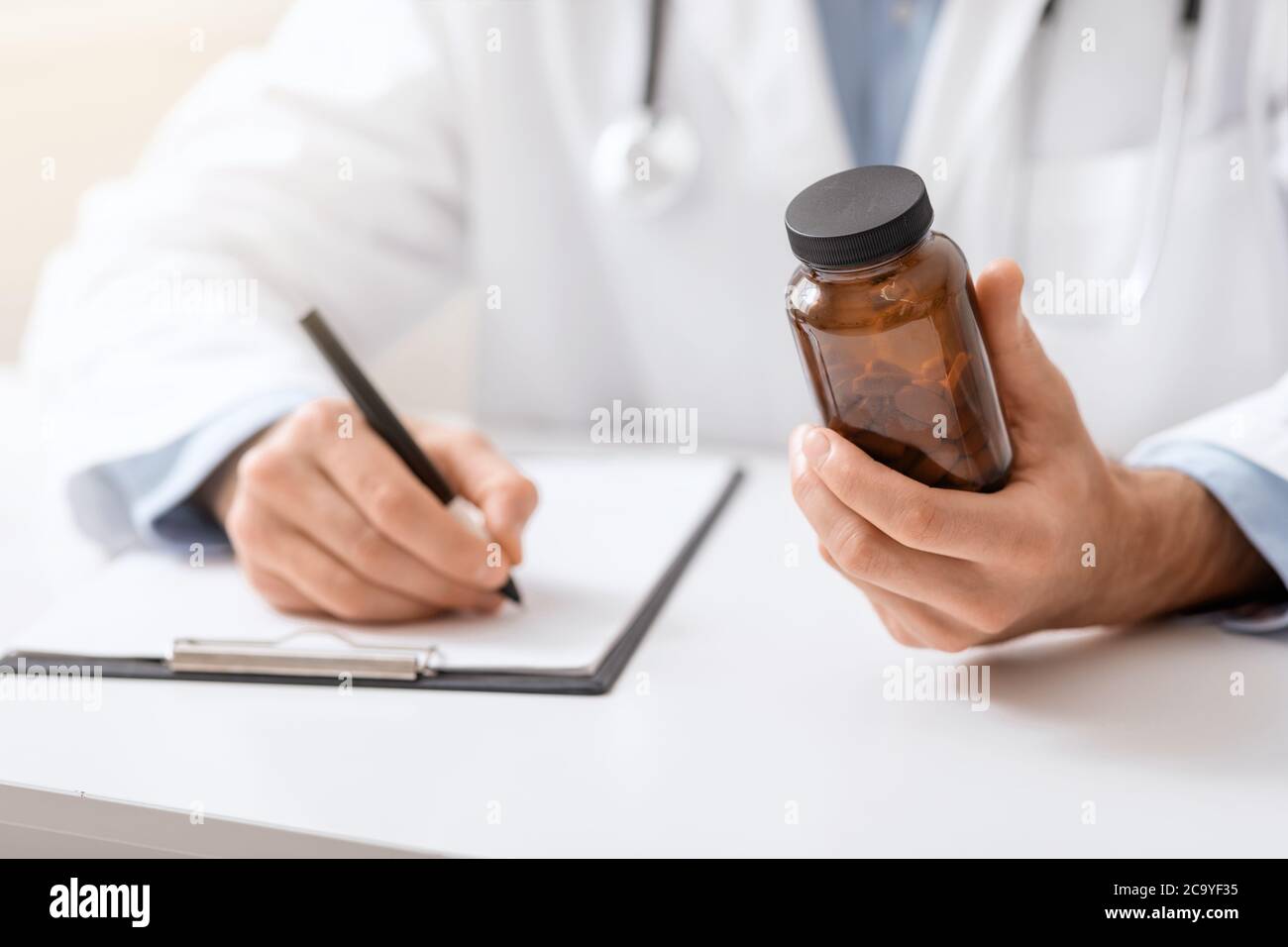 Medical doctor writing prescription for patient about pills Stock Photo ...