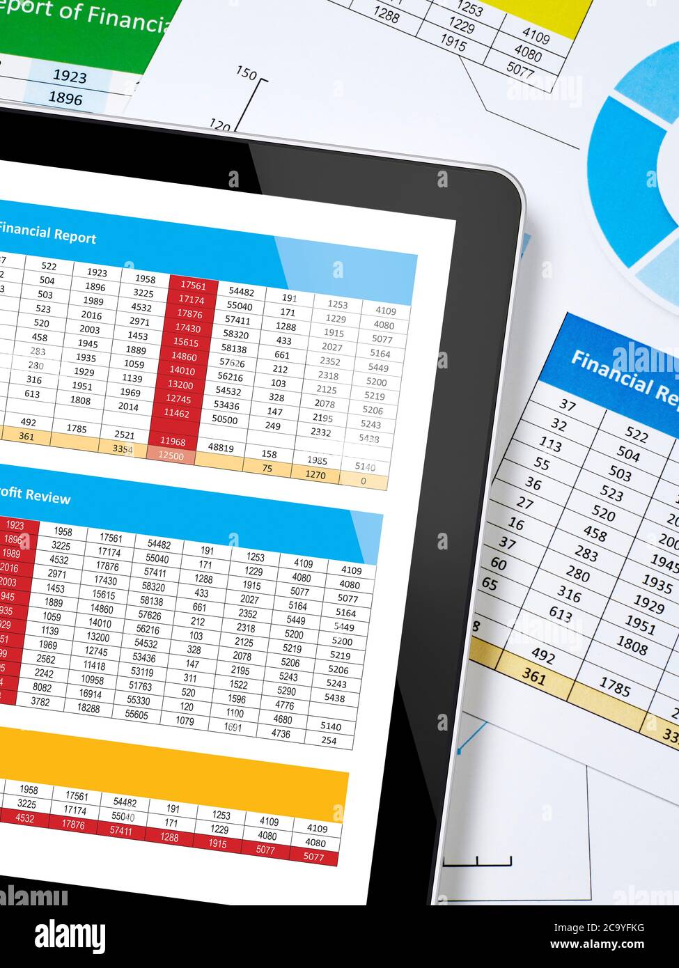 Financial data on digital tablet and papers Stock Photo - Alamy