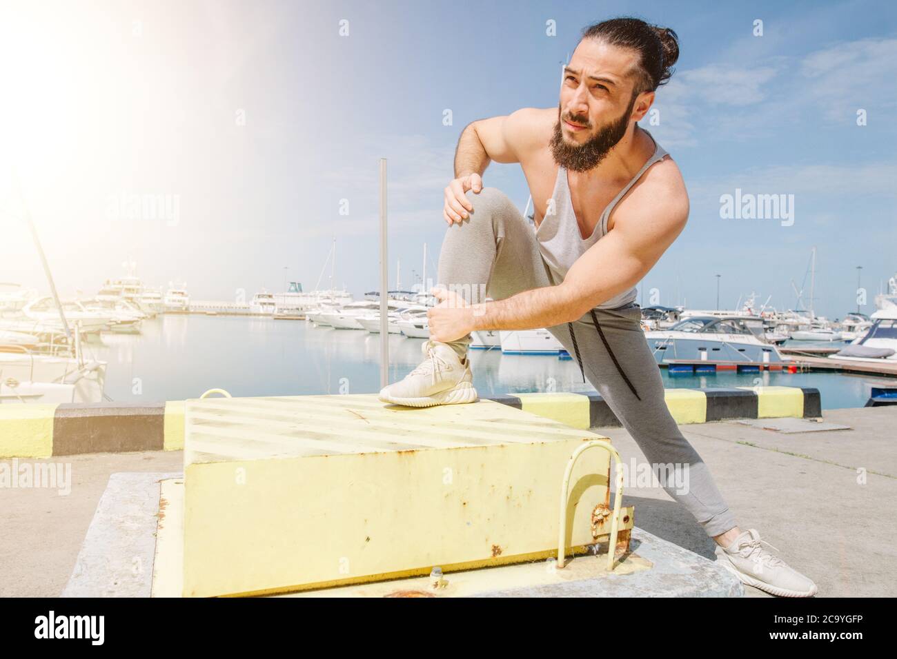 Professional muscular boxer or fighter stretching his body at the ...
