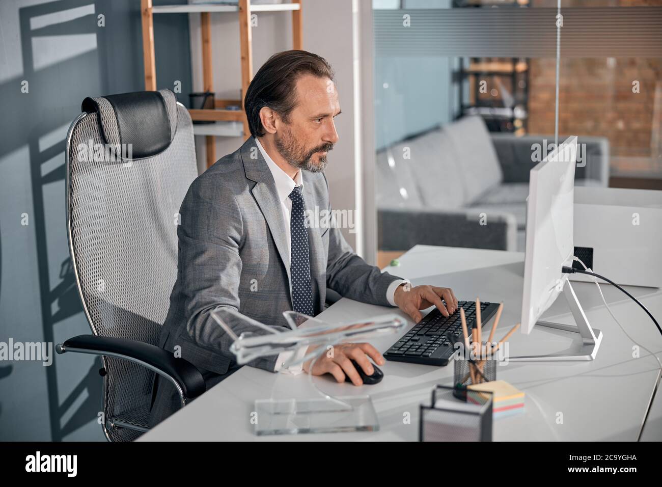 Serious man using modern computer at work Stock Photo - Alamy