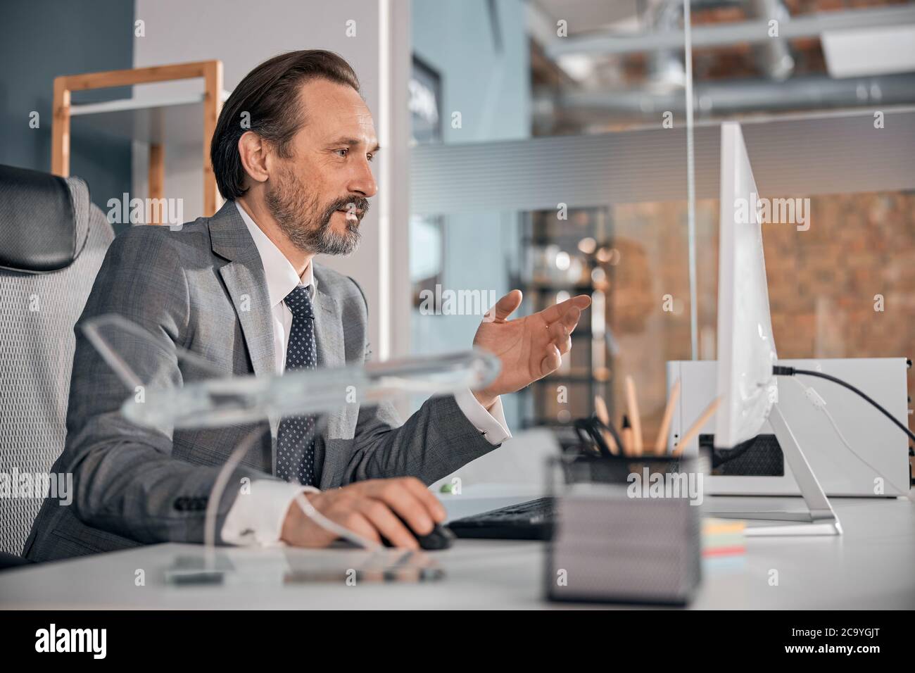 Good-looking gentleman using modern computer at work Stock Photo - Alamy