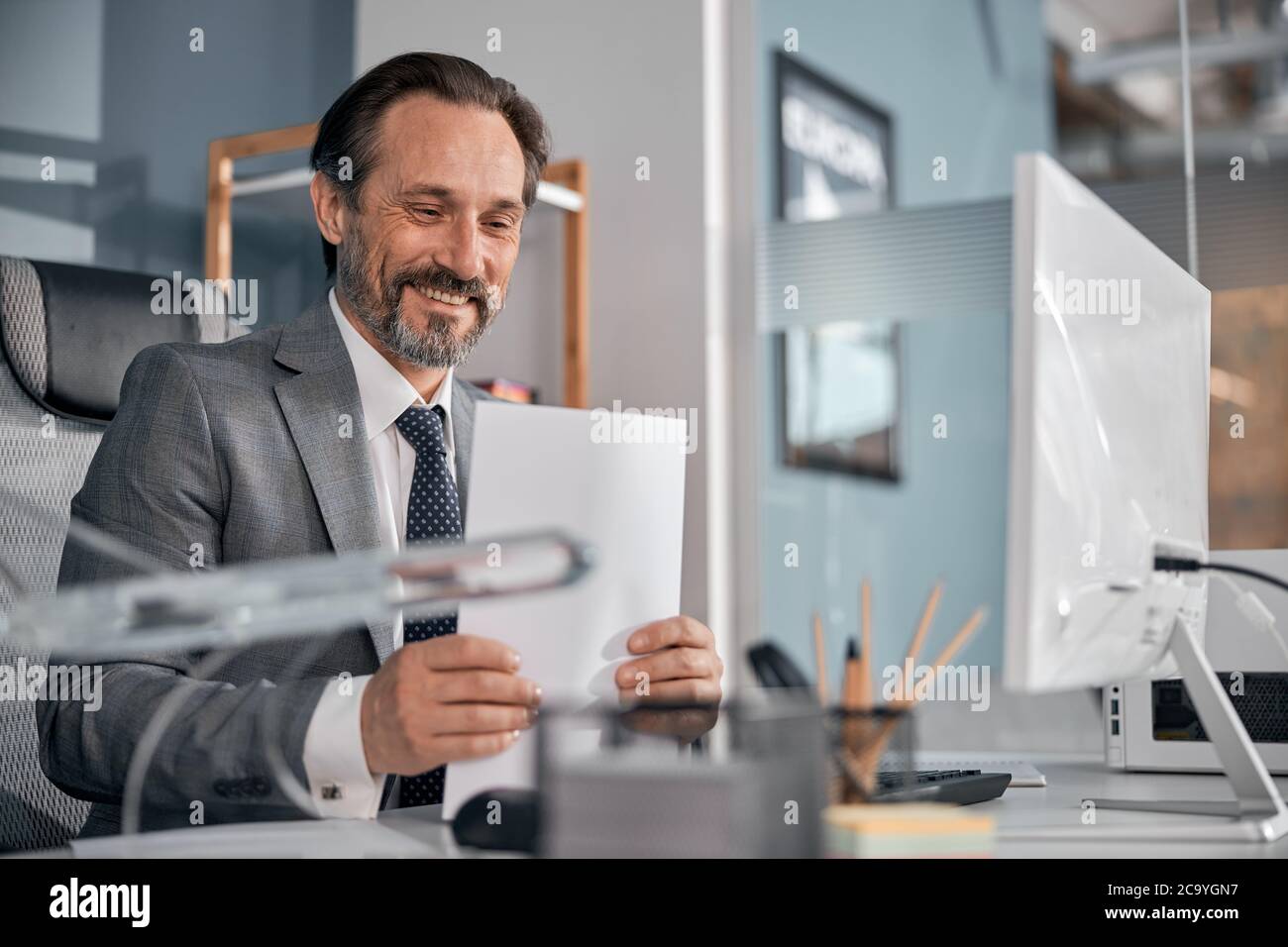 Cheerful man working documents hi-res stock photography and images - Alamy