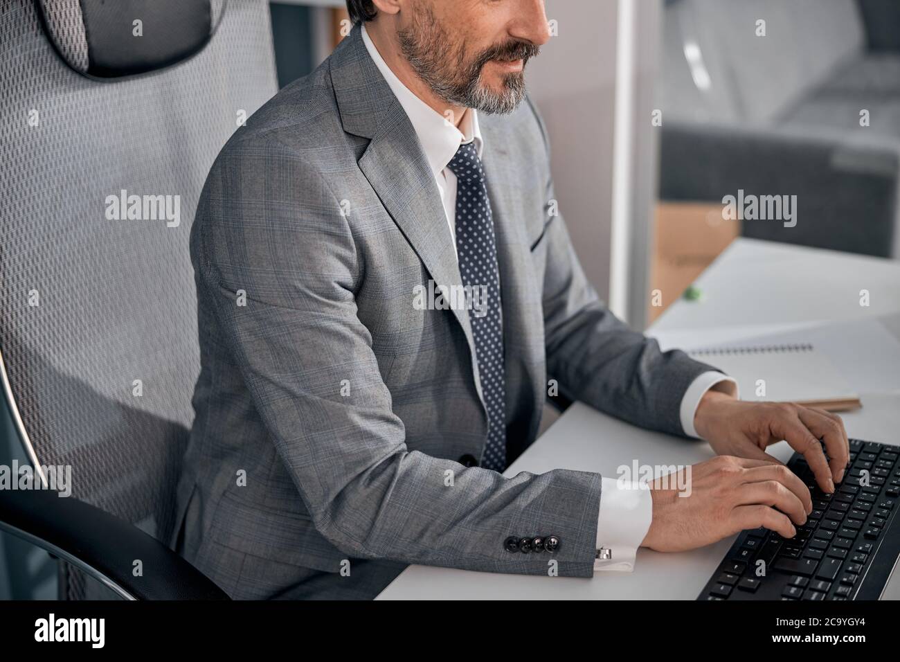 Male office worker using computer in office Stock Photo - Alamy
