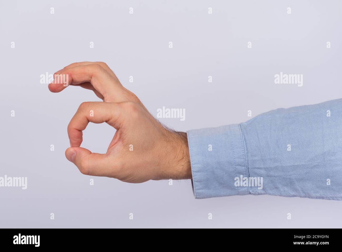 Male hand showing an ok sign with fingers. OK Gesture on white ...