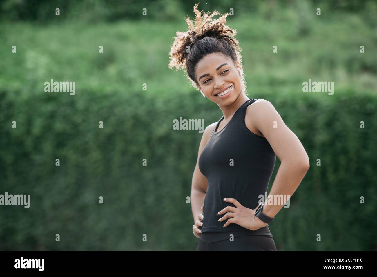 Sports model or fitness blogger. Smiling girl in sportswear with ...