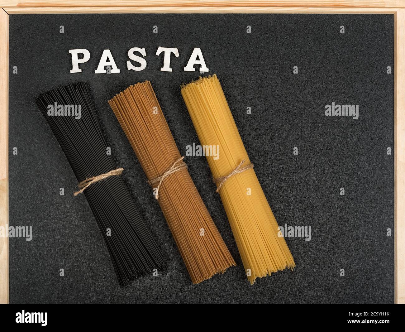 Different types of spaghetti on gray background and words Pasta. top ...