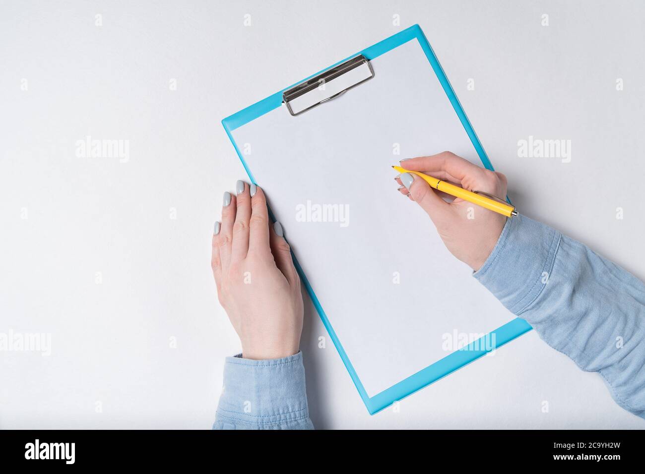 Female hands with pen on document. Woman puts signature on paper. Top ...