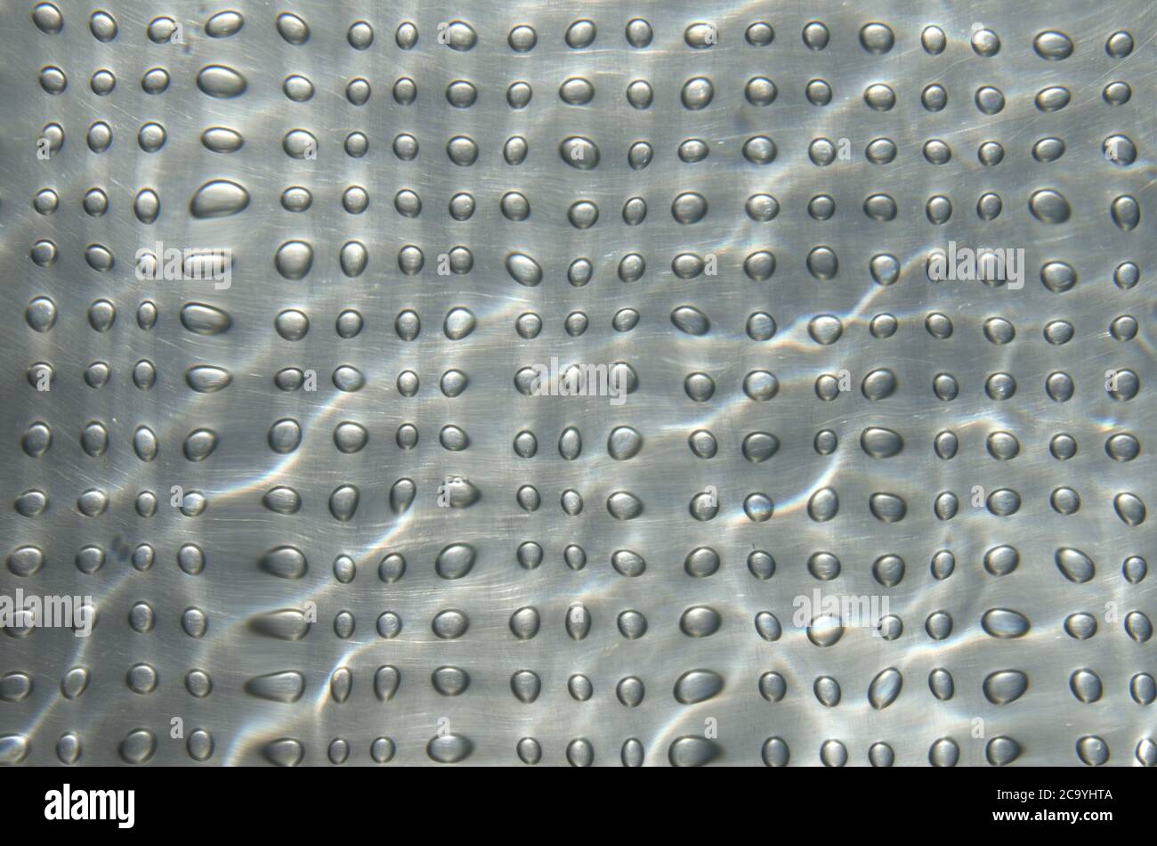 Gray metallic background: stainless steel pool floor with distorted ...