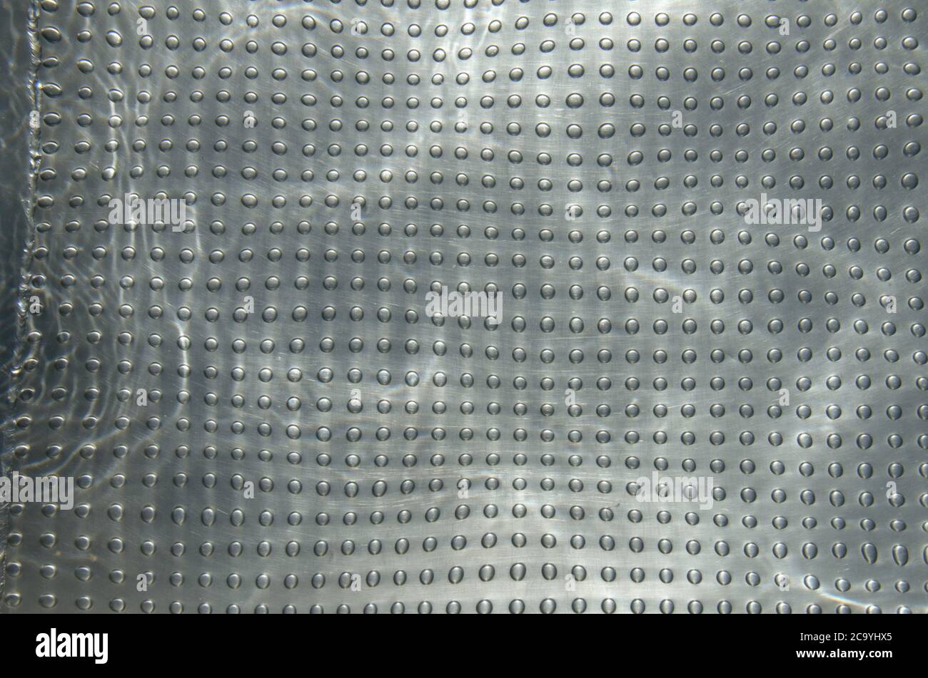 Gray metallic background: stainless steel pool floor with distorted ...