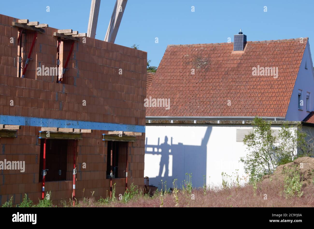Building site with shadow of a construction worker on scaffoldings ...