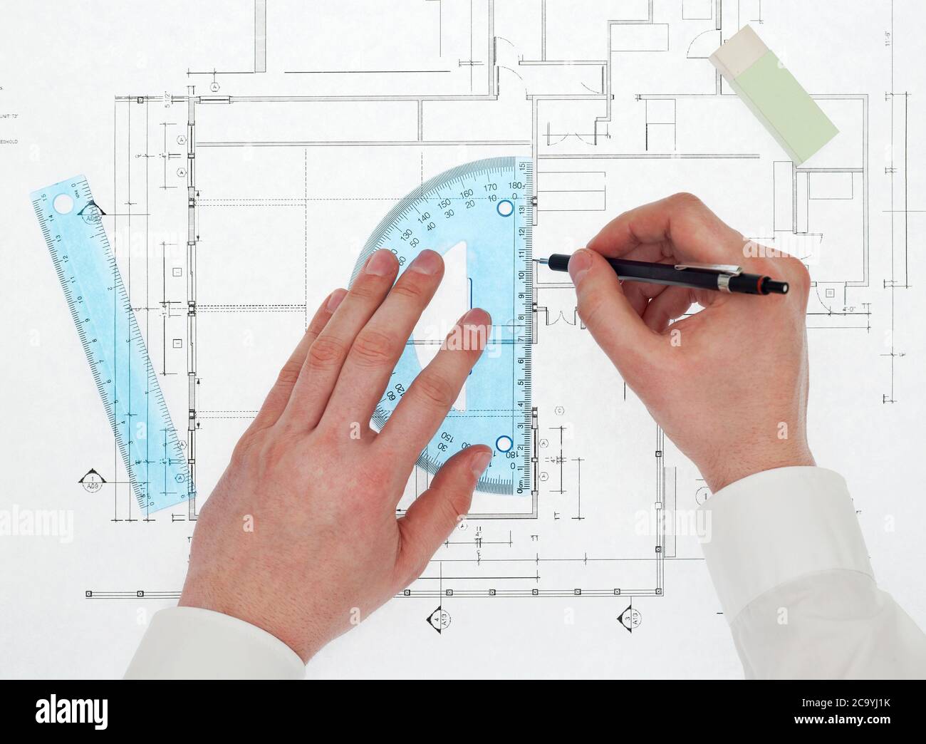 Architect drawing on blueprint Stock Photo - Alamy