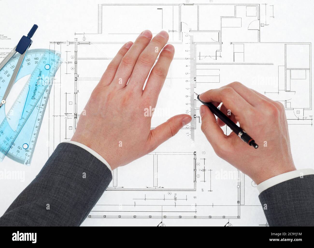 Architect working on blueprints Stock Photo - Alamy