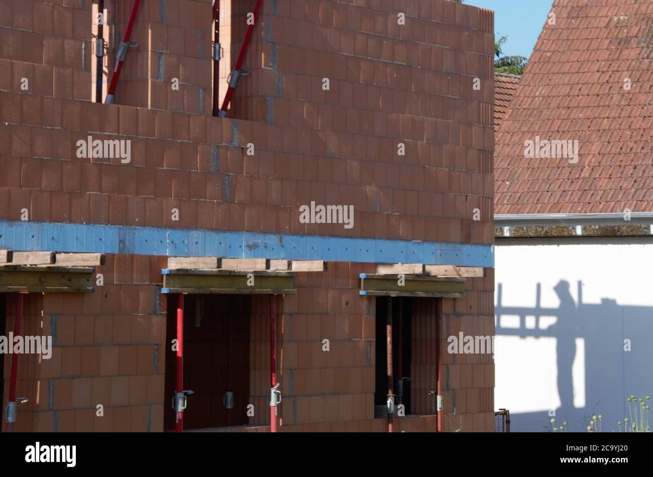 Building site with shadow of a construction worker on scaffoldings ...
