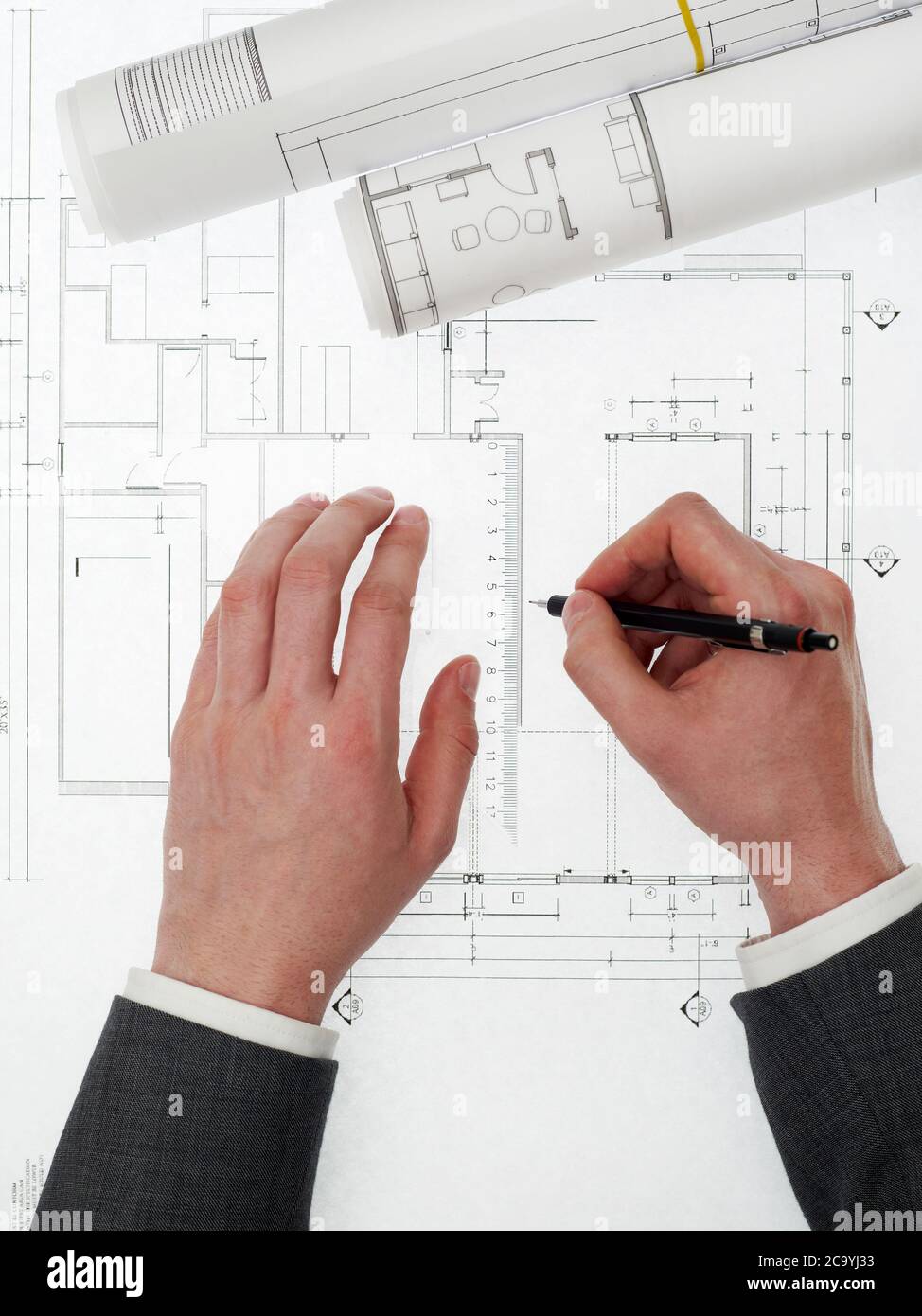 Architect drawing a blueprint Stock Photo - Alamy