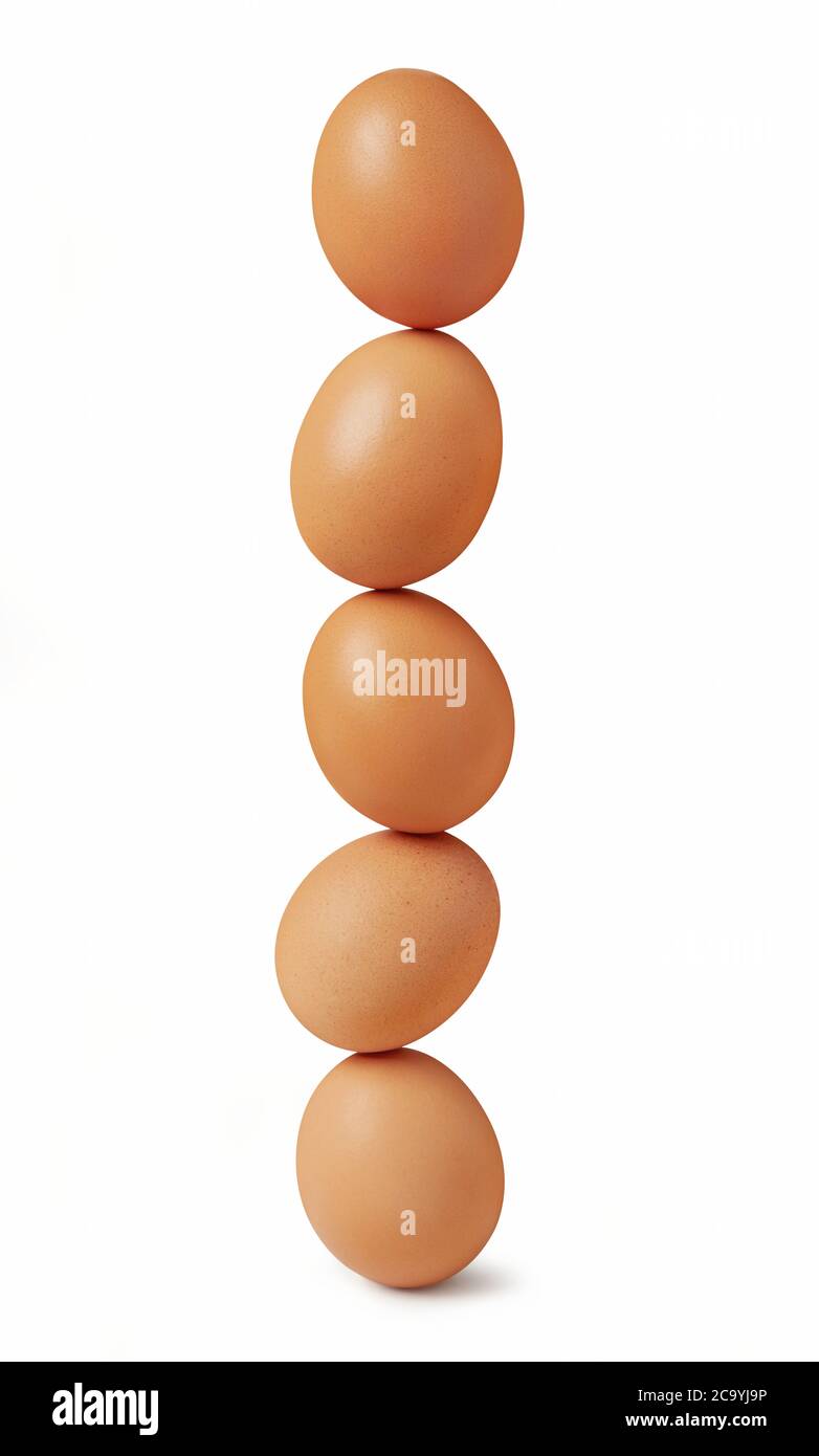 Balanced eggs isolated on white Stock Photo - Alamy