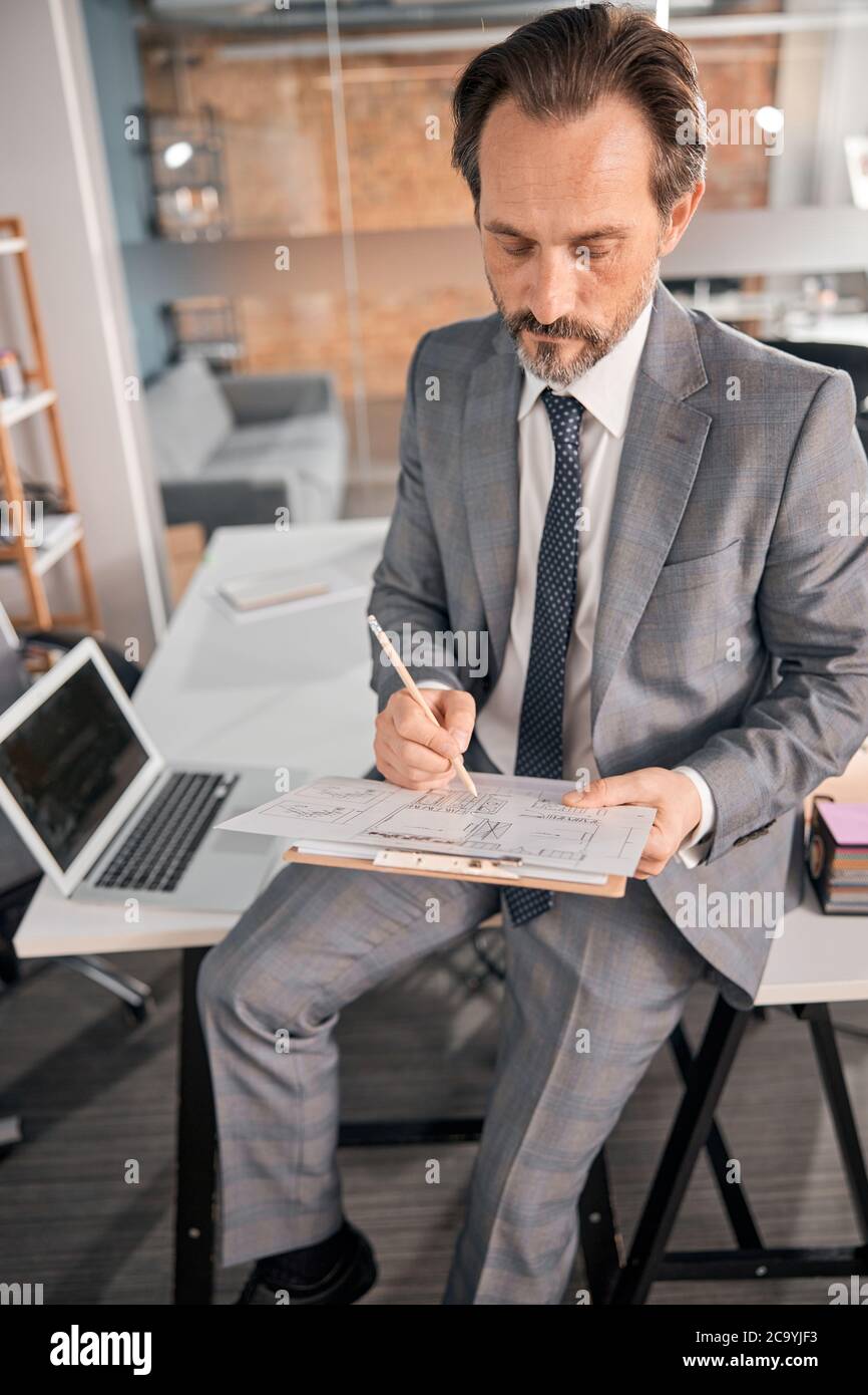 Handsome businessman writing document hi-res stock photography and ...