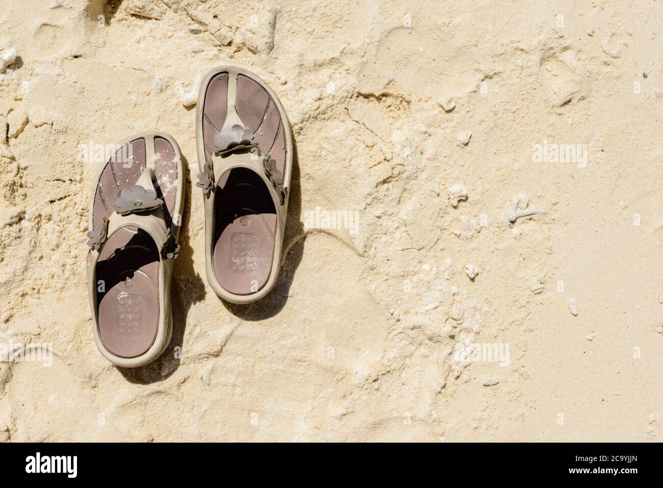 Pair of slippers on sand at the beach Stock Photo - Alamy