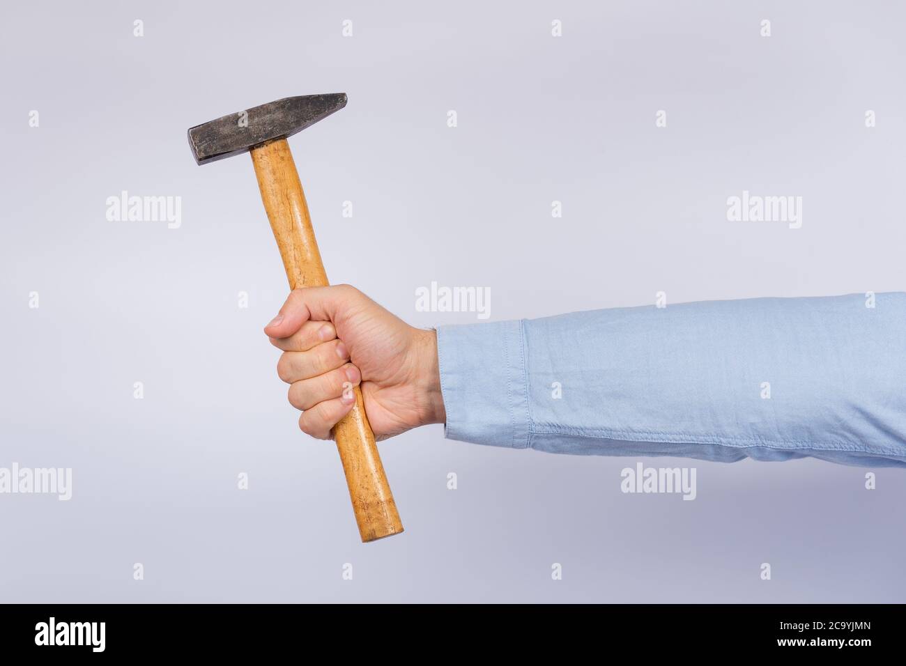 Male hand holding hammer on white background. Claw hammer Side view ...