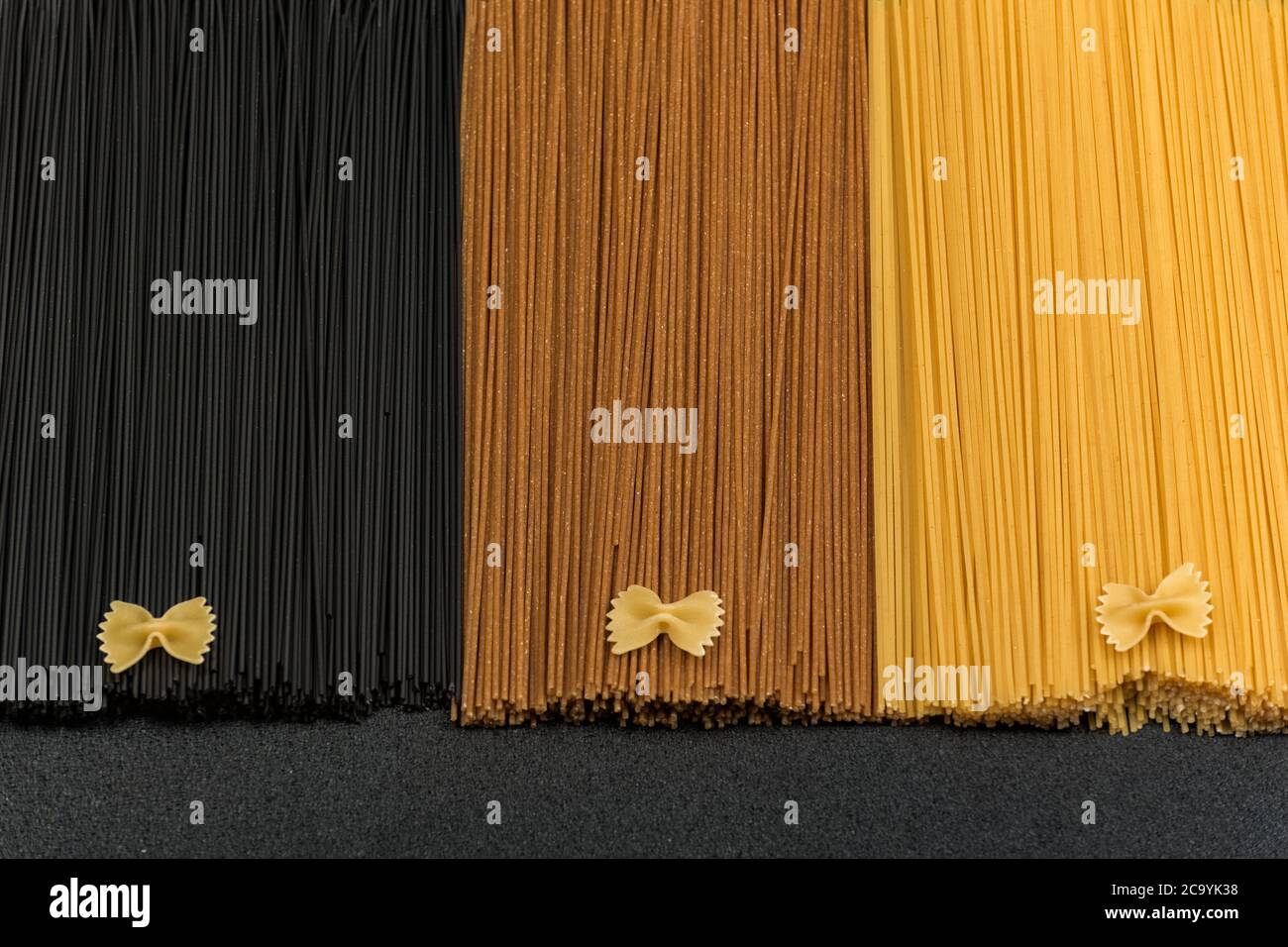 Black, brown and light spaghetti. Different types of Italian spaghetti ...