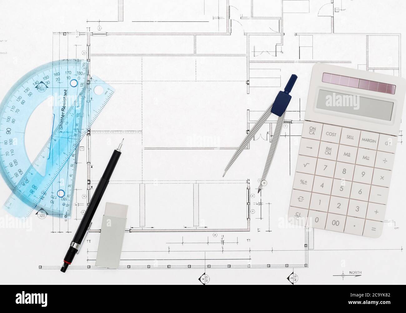 Calculator and blueprint Stock Photo - Alamy