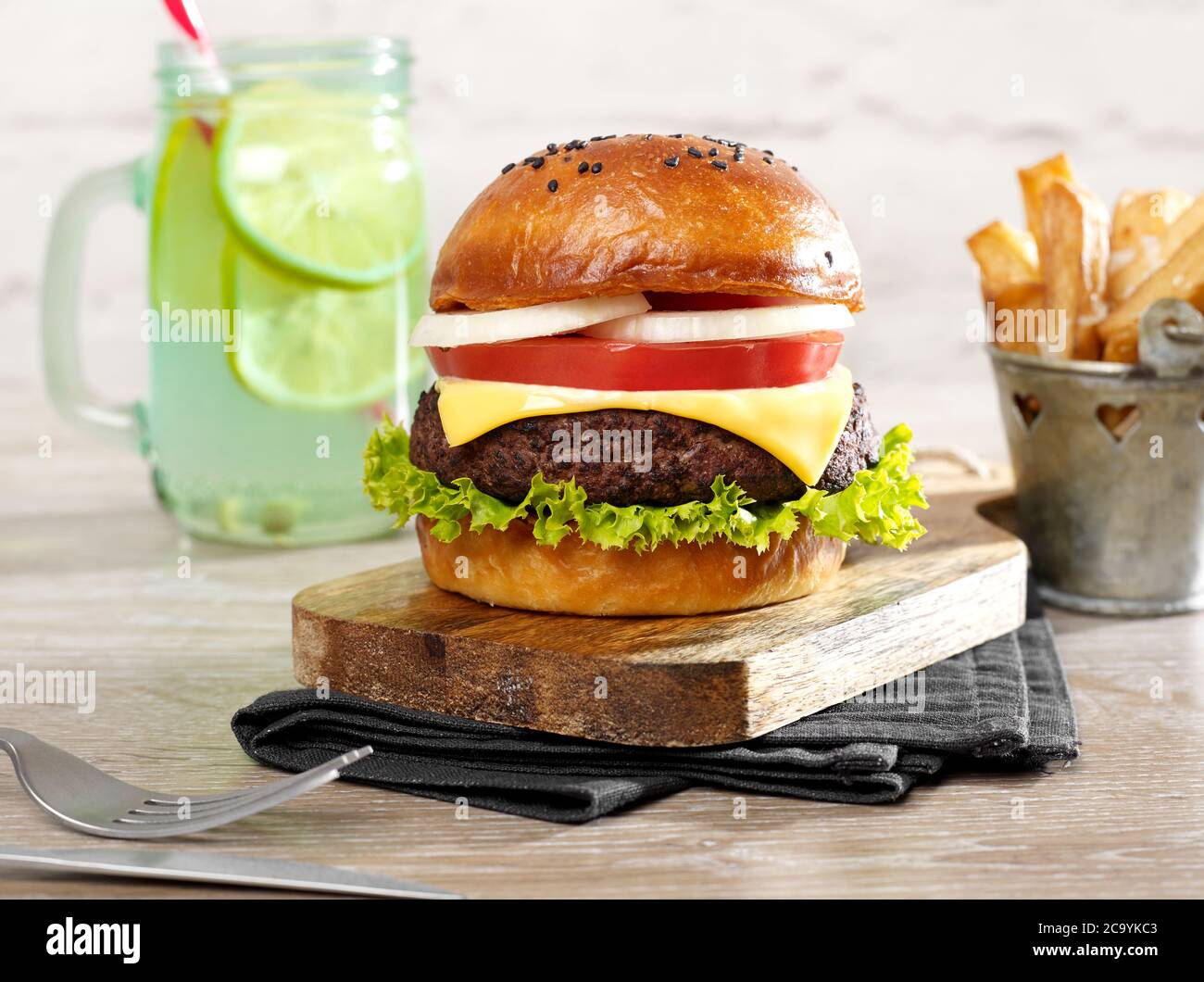 Cheeseburger with fries and drink Stock Photo - Alamy