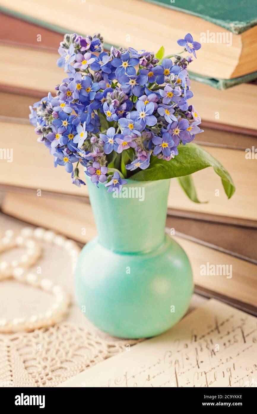 Forget me not flowers and old books Stock Photo - Alamy