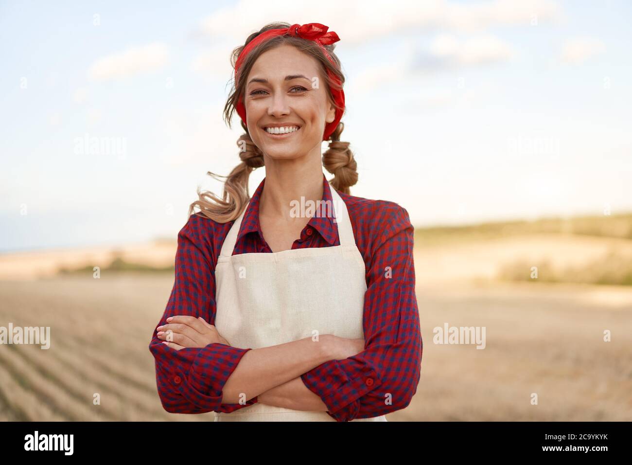 Woman farmer apron standing farmland smiling Female agronomist ...