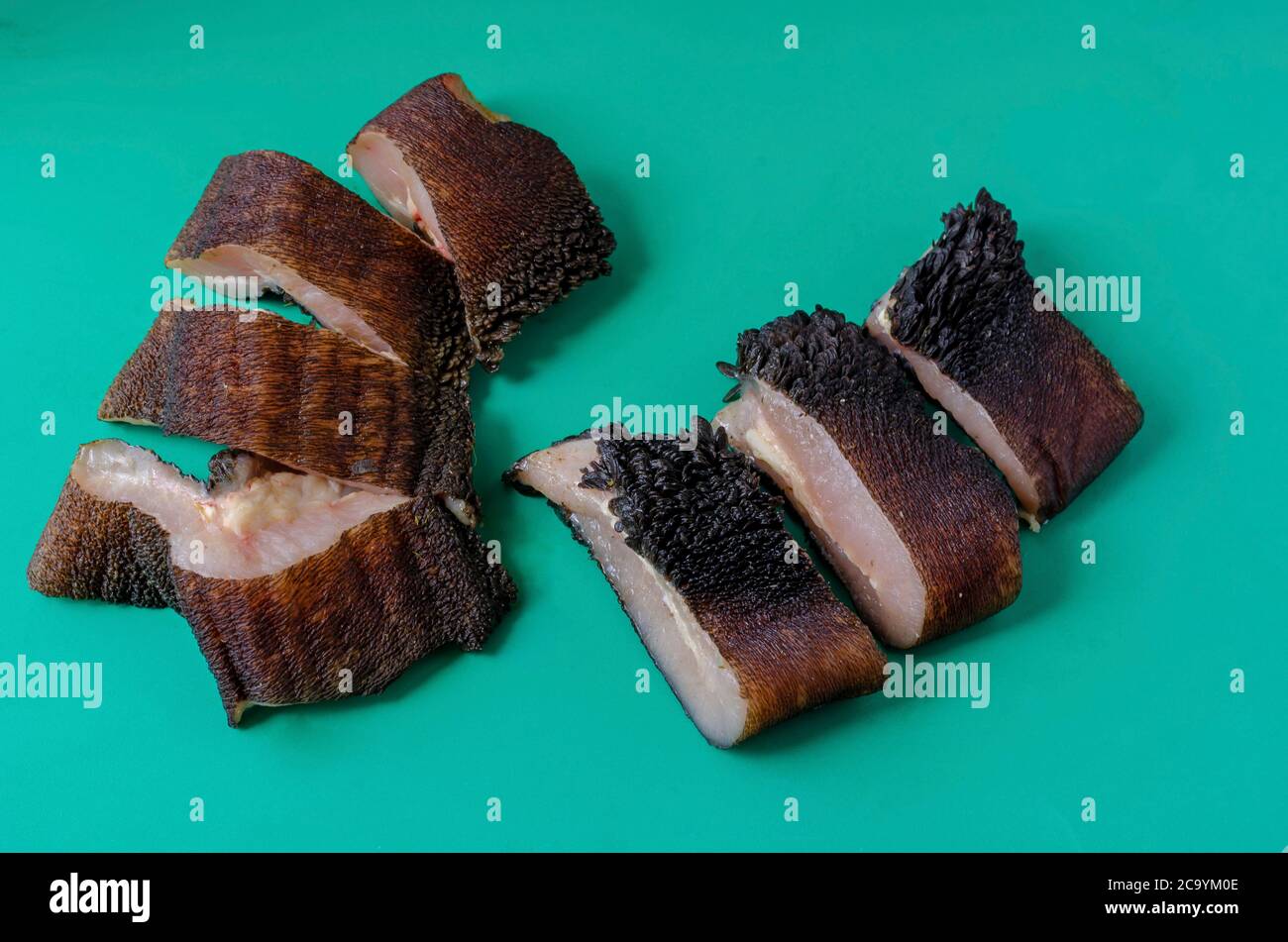 Pieces of raw cow stomach on turquoise. Random pieces Black unpeeled ...