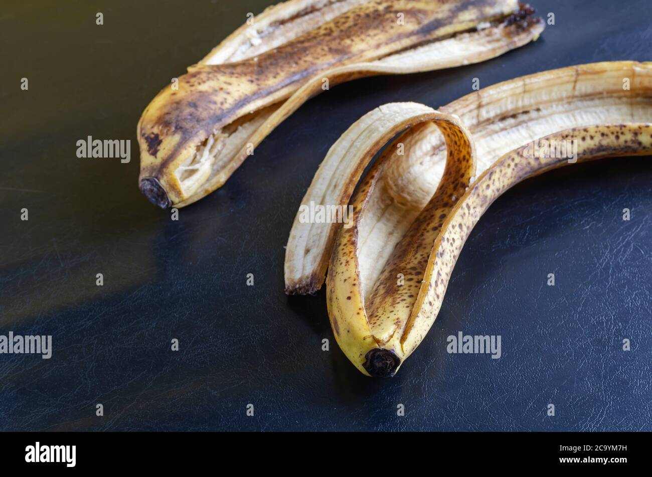Detailed photo Discarded banana peel on black background. The peel of ...