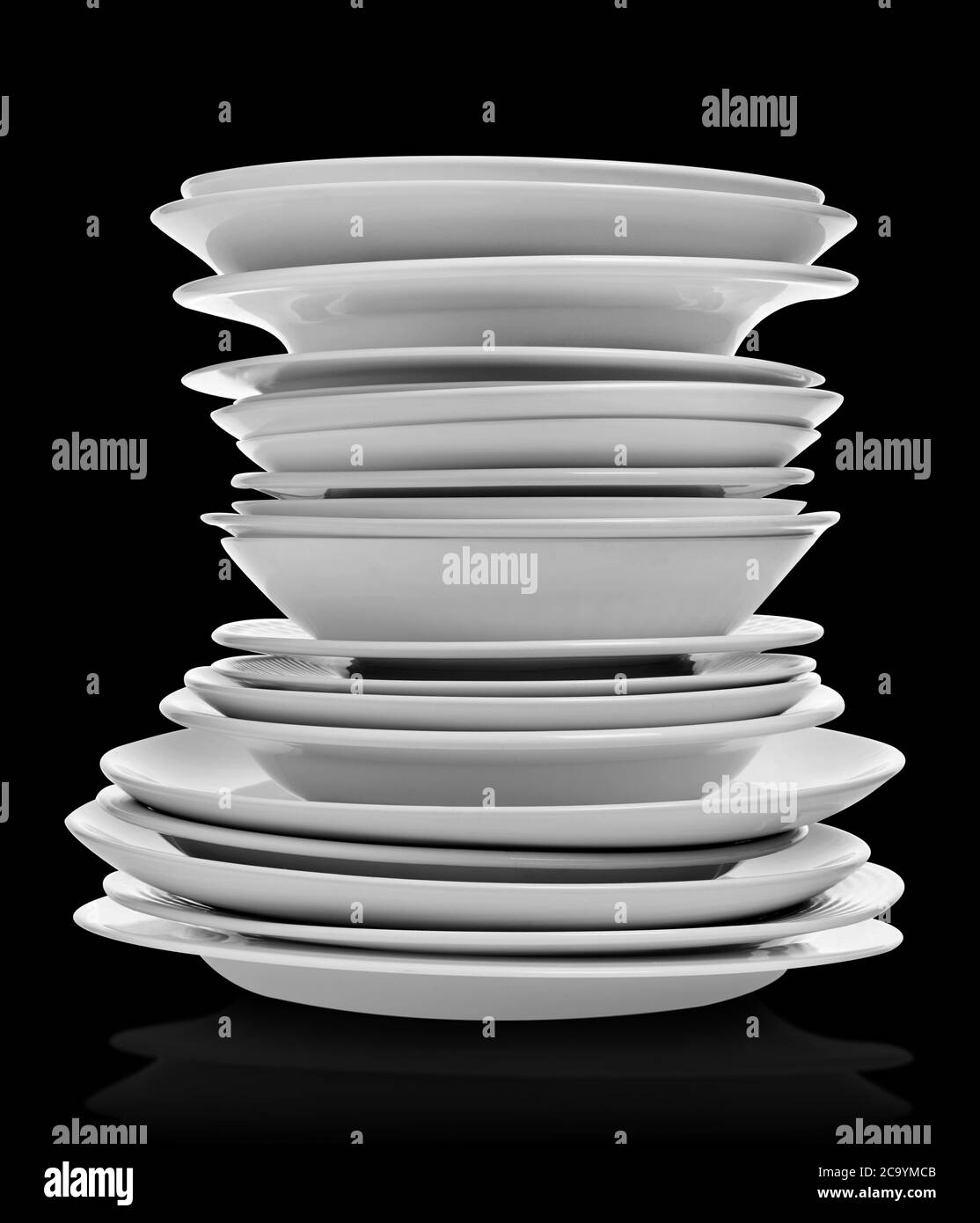 Clean plates stack isolated on black Stock Photo - Alamy