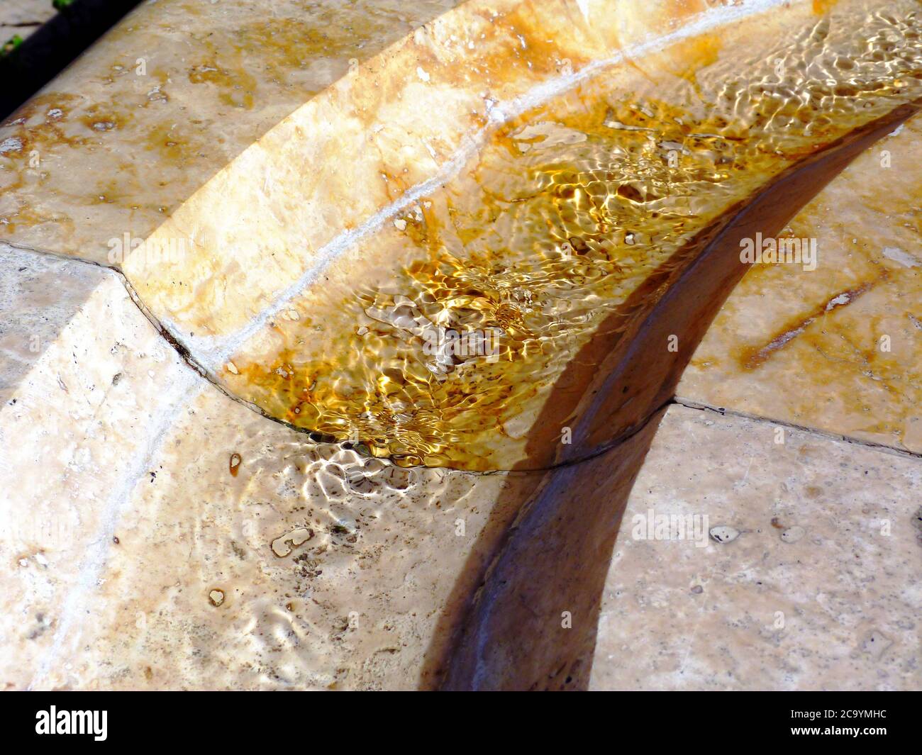 shallow stream of clear fresh water flowing and cascading in carved ...