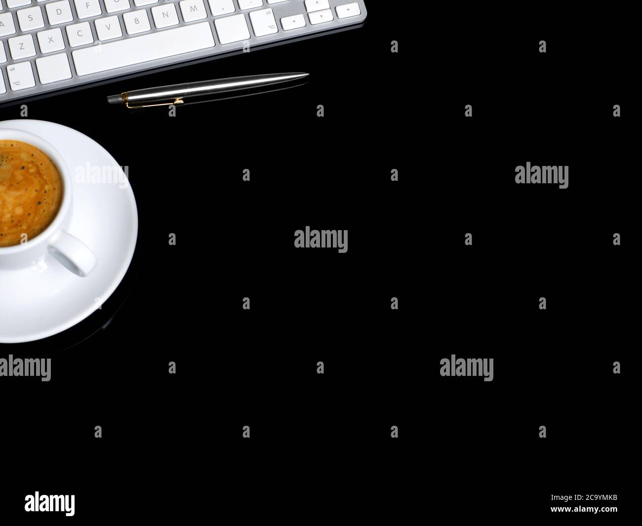 Coffee, pen and keyboard on black Stock Photo - Alamy