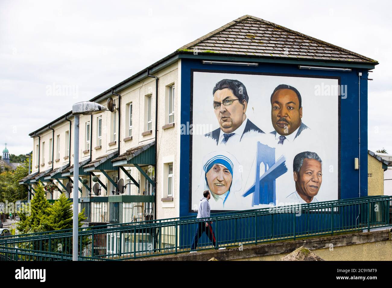 A man walks past the Bogside mural in Derry City of John Hume, Martin ...