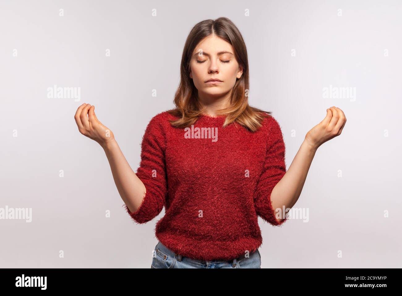 Zen, inner peace. Portrait of calm girl in shaggy sweater concentrating ...
