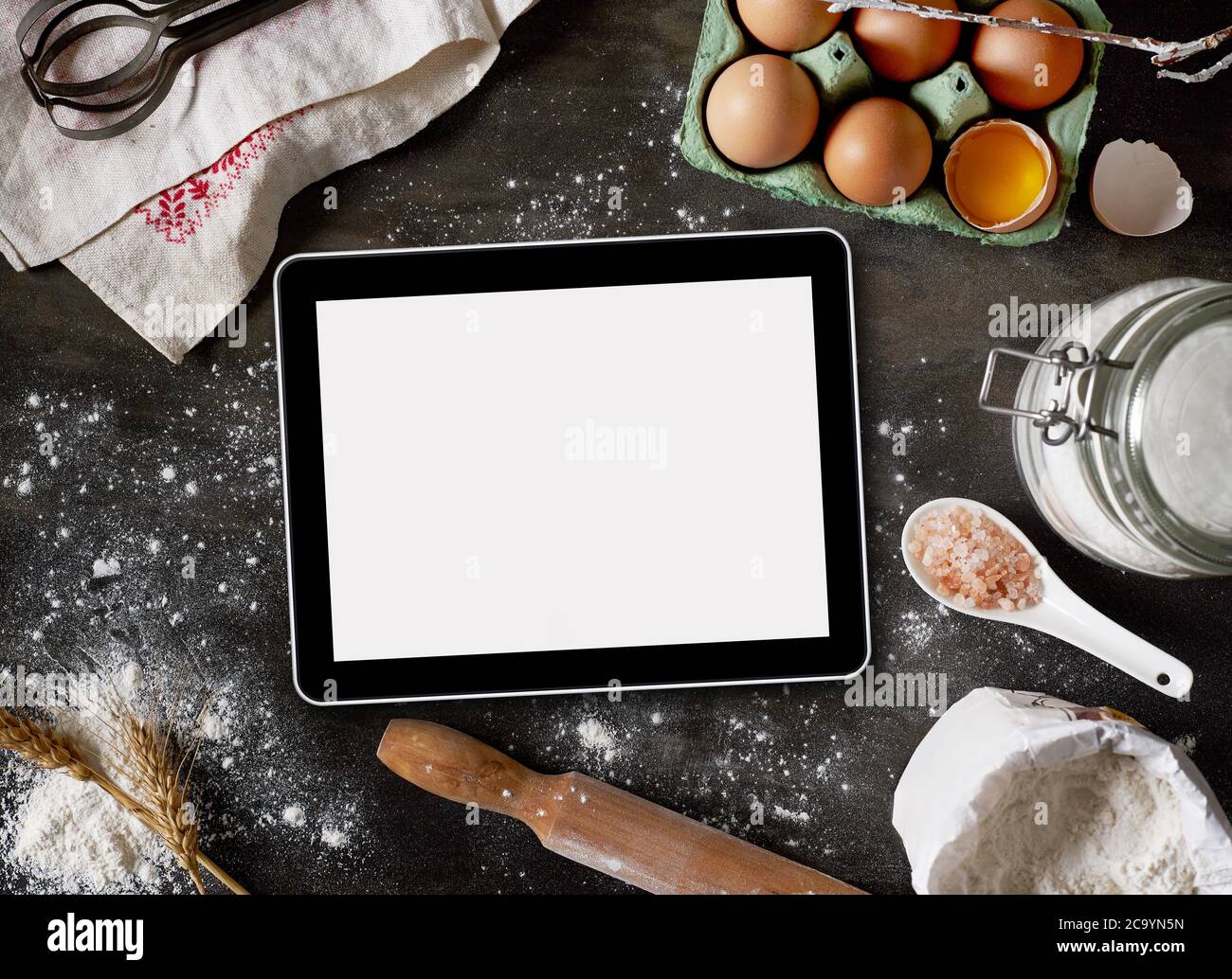Digital tablet and baking ingredients Stock Photo - Alamy