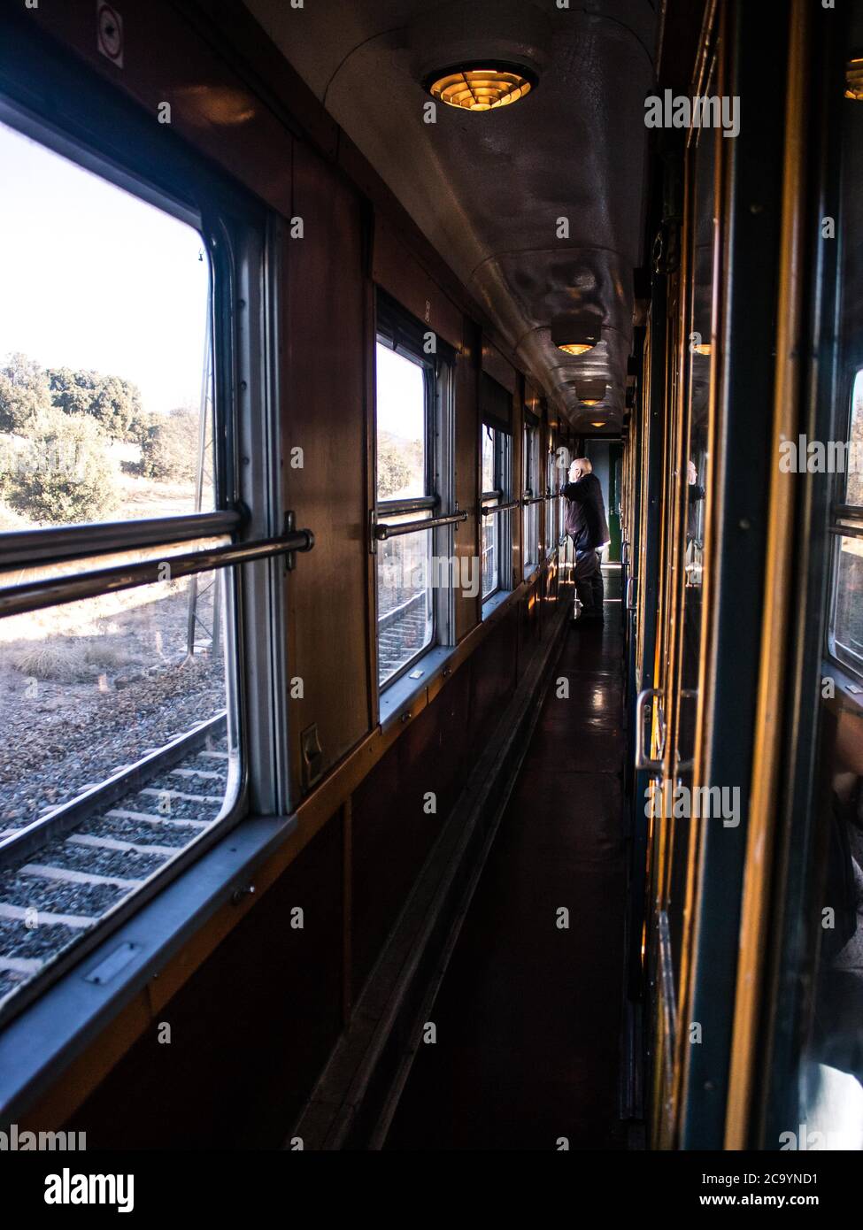 Passenger looking out of the window of the moving train Stock Photo - Alamy