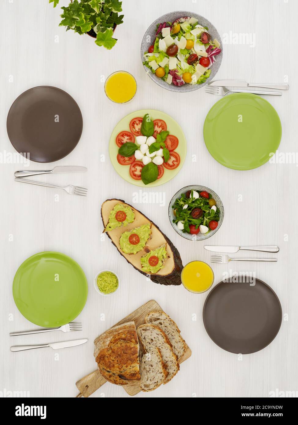 Empty plates on dinner table Stock Photo - Alamy