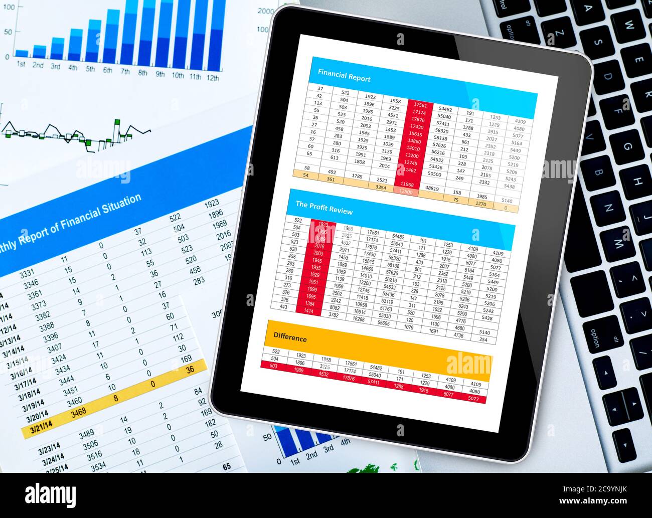Financial data on digital tablet and papers Stock Photo - Alamy