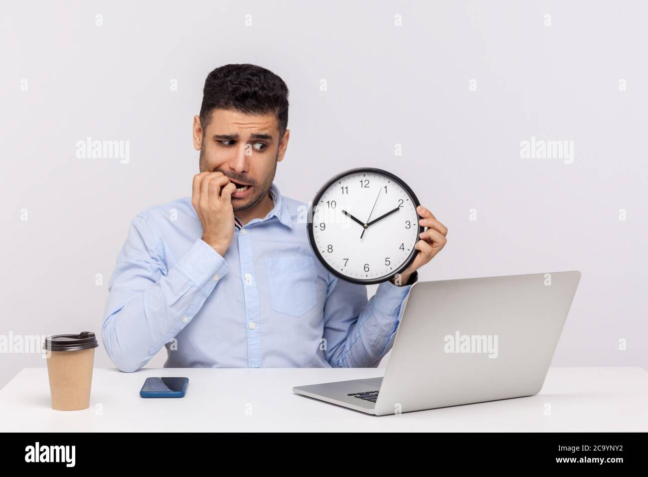 Deadline concept. Nervous anxious man employee sitting in office ...