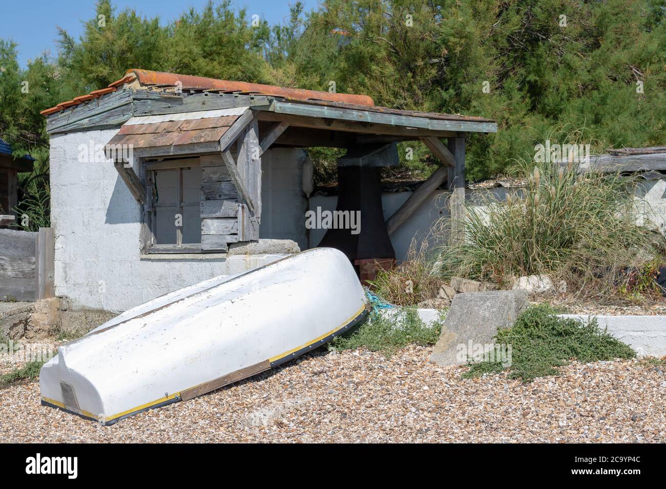 rustic scene of a boat by a beach hut Stock Photo - Alamy