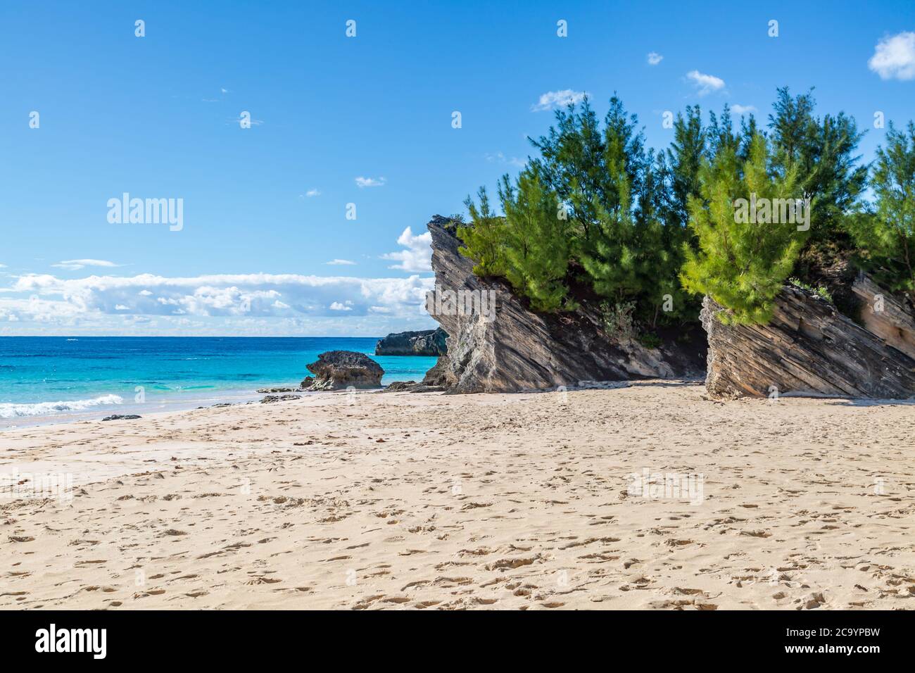 Rock formations and green foliage at Horseshoe Bay beach, on the island ...