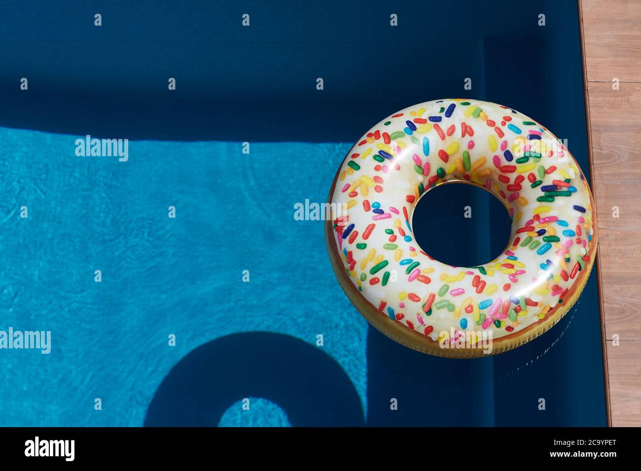 Inflatable donut ring in blue swimming pool, top view Stock Photo - Alamy